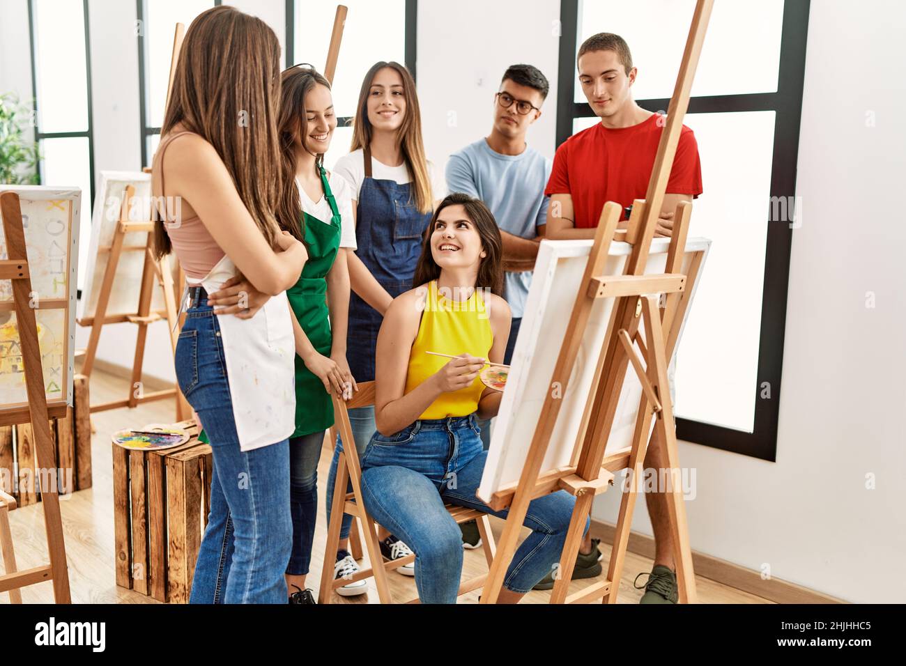 Group of people smiling happy and looking draw of partner at art studio ...