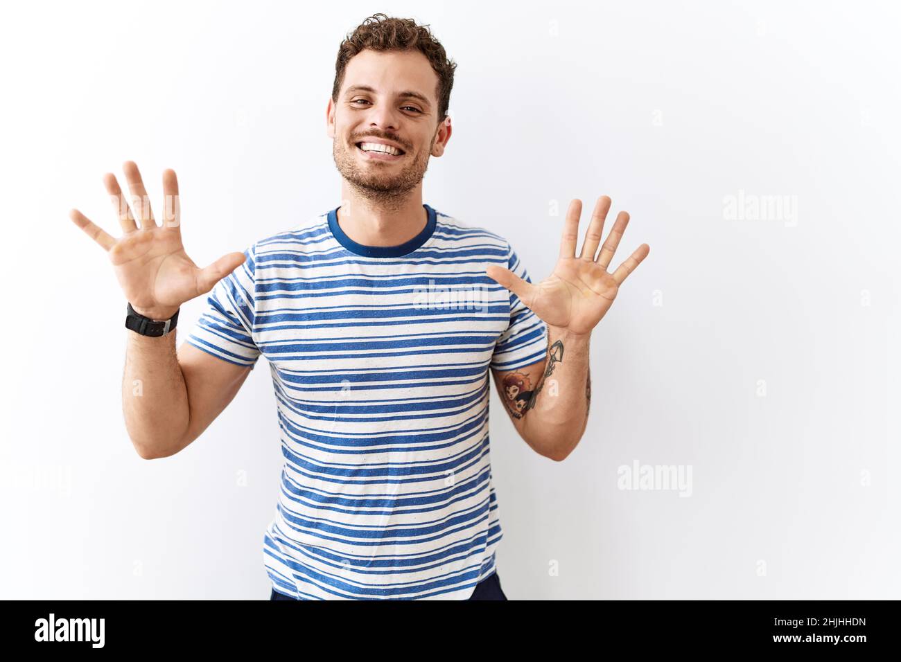Handsome young man standing over isolated background showing and ...