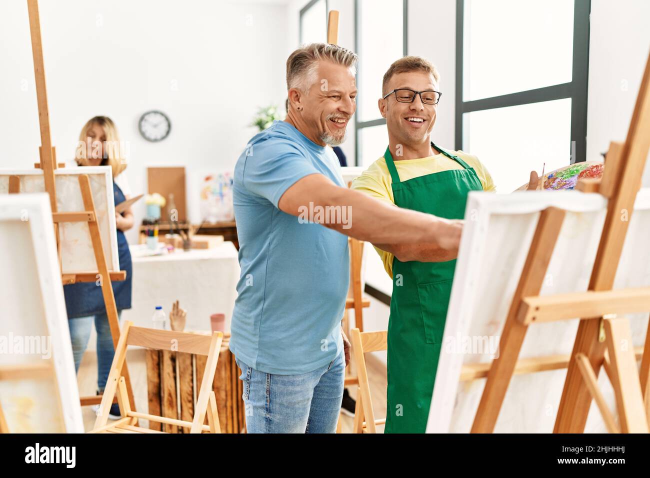 Group of middle age paint students drawing at art studio. Teacher ...