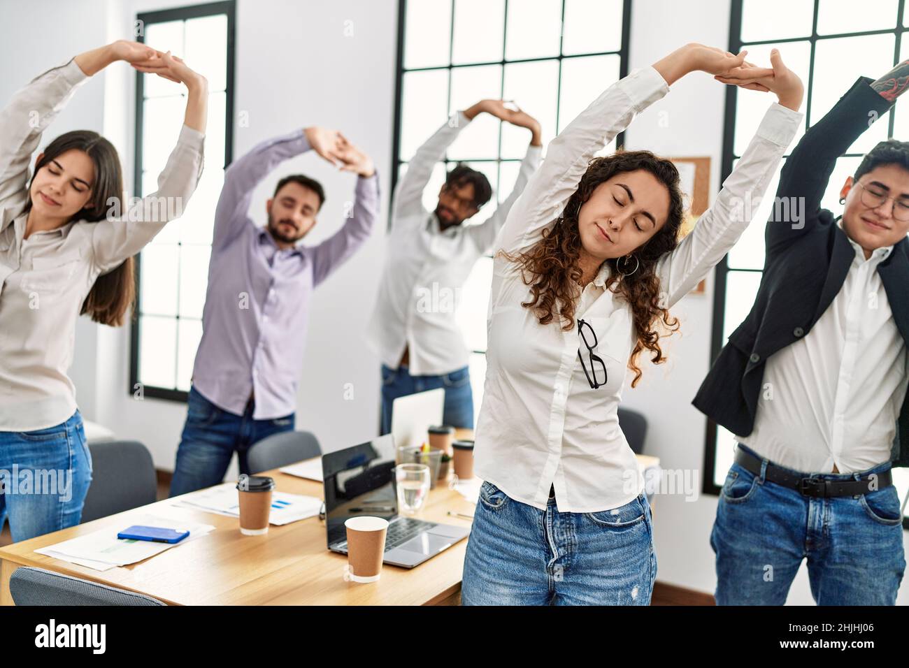 Group of business workers stretching arms in relax time standing at the ...