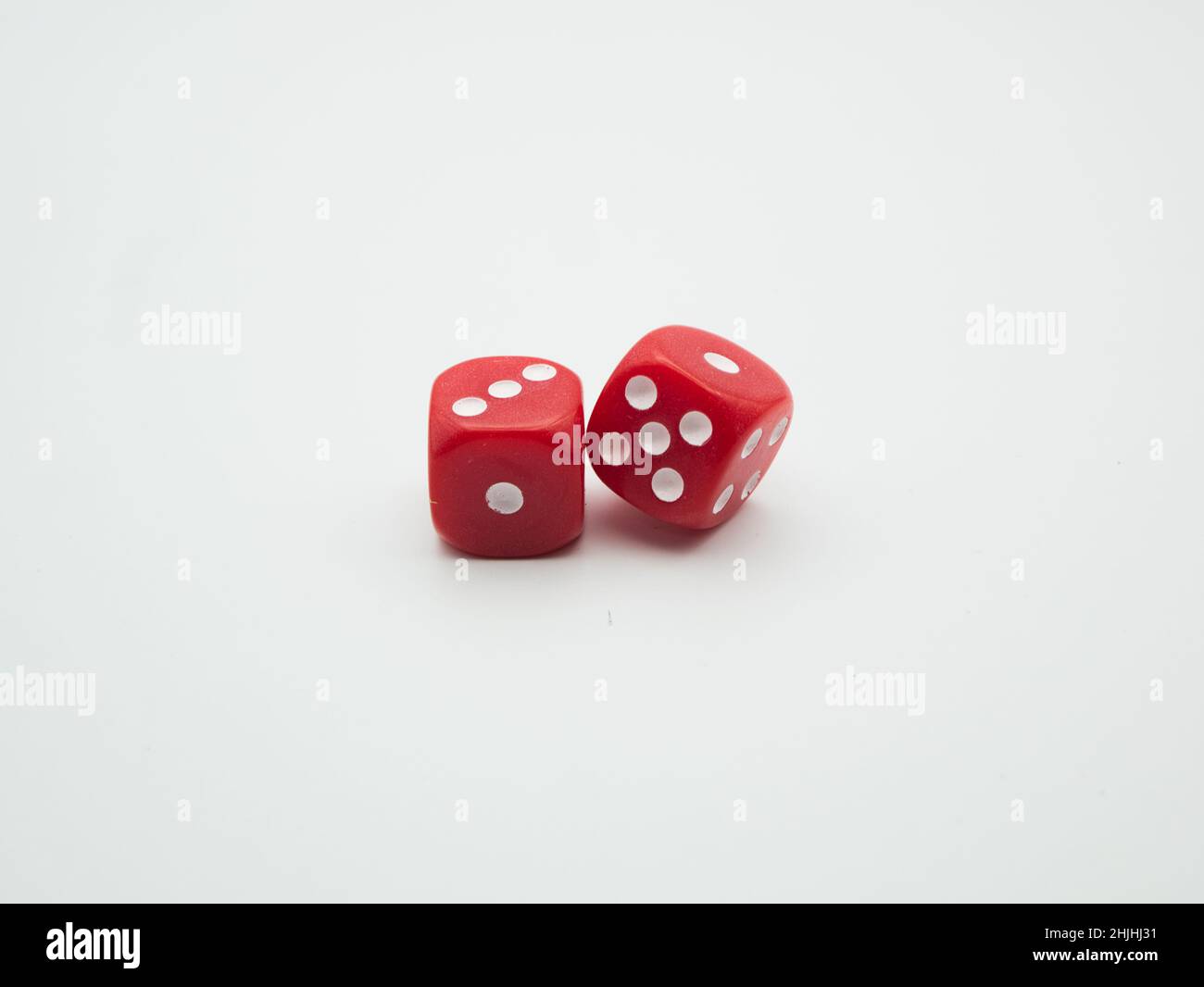 Two red dice isolated on white background Stock Photo - Alamy