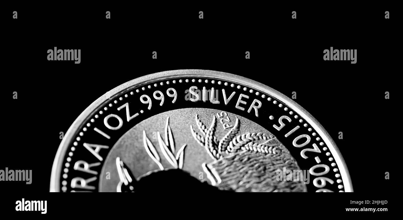 Macro Close up of Silver Bullion Coin on a black mirror background ...