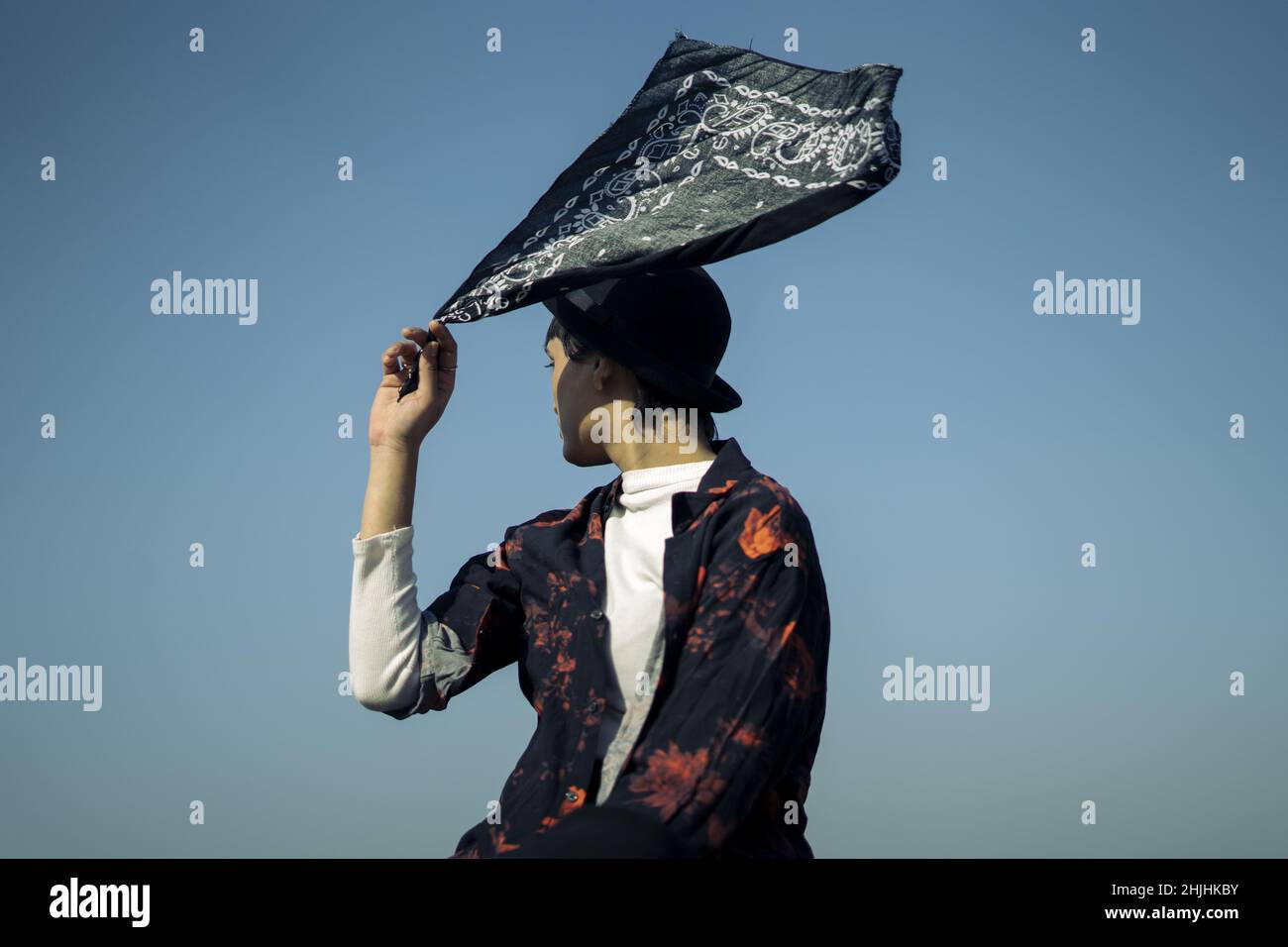 Artistic portrait of an Indian female holding a handkerchief against ...
