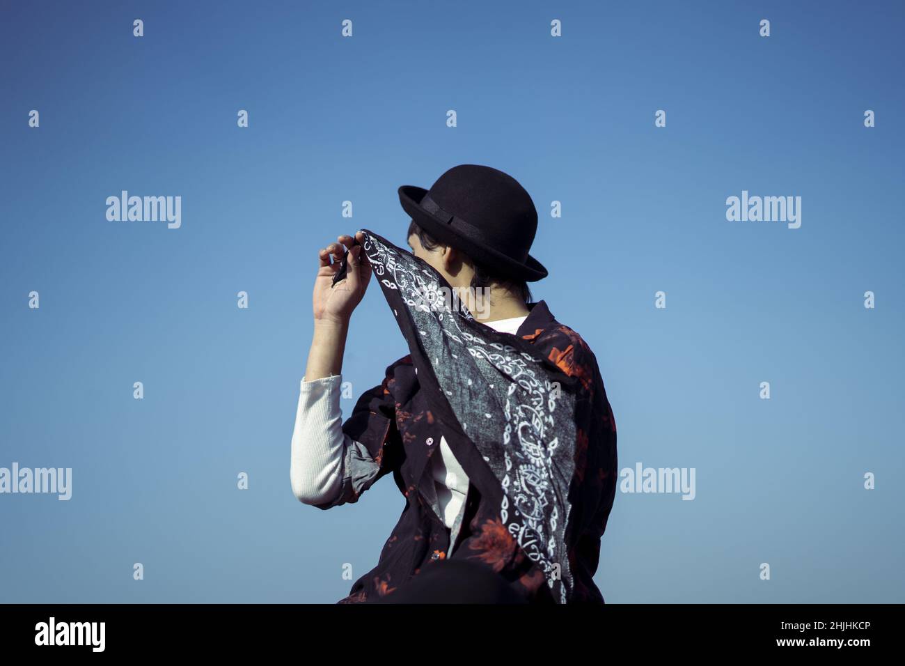 Artistic portrait of an Indian female holding a handkerchief against ...