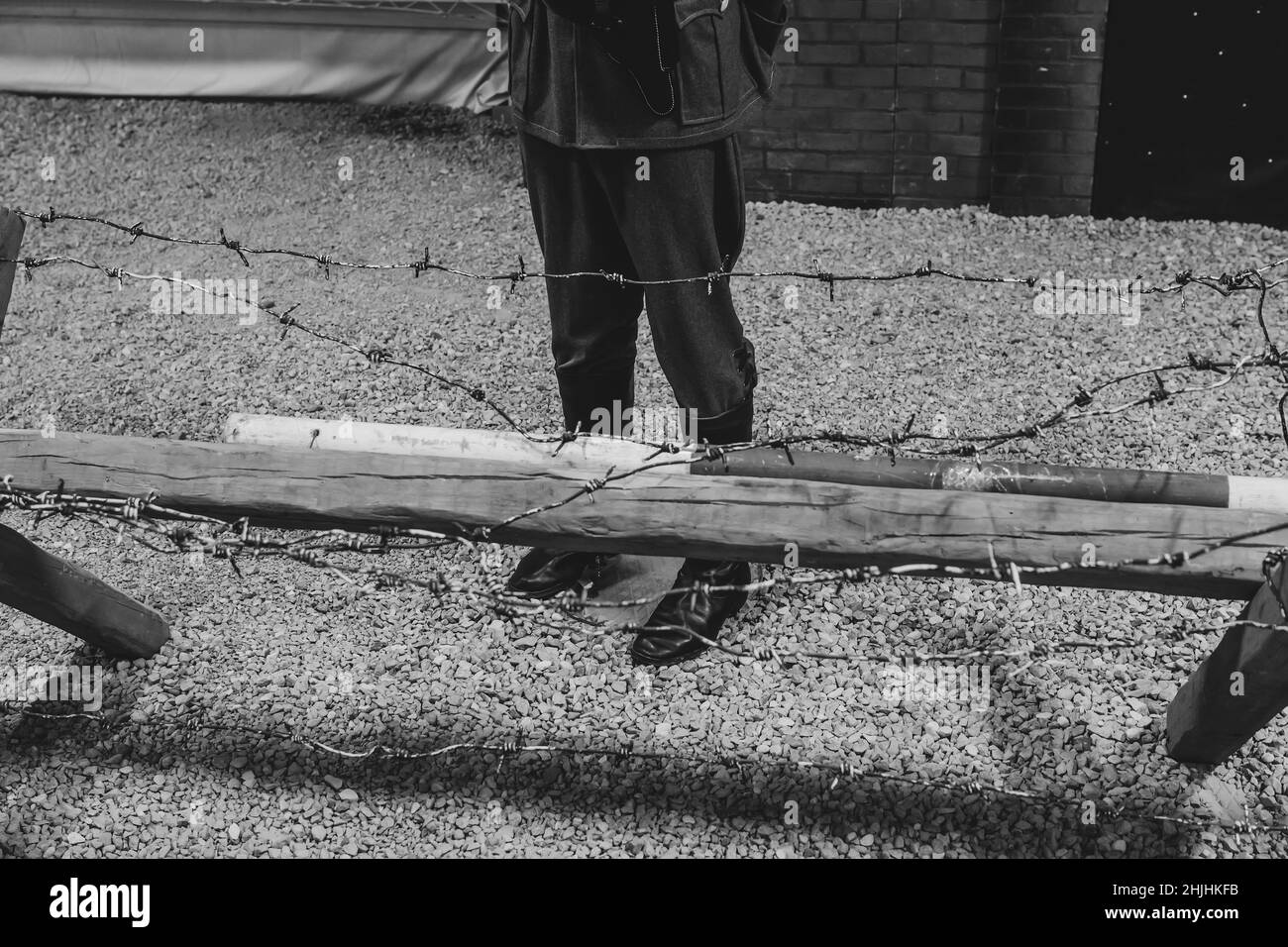 a soldier in a German uniform during the Second World War stands behind ...