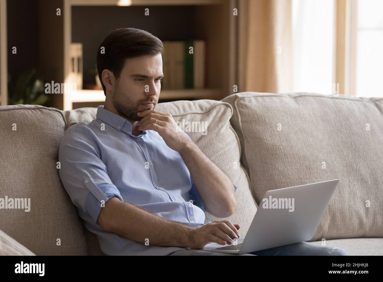 Thoughtful young man working hi-res stock photography and images - Alamy