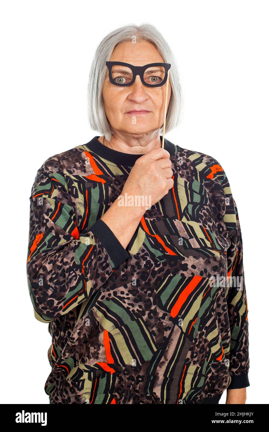 Elderly woman having fun with photo booth accessories on isolated ...