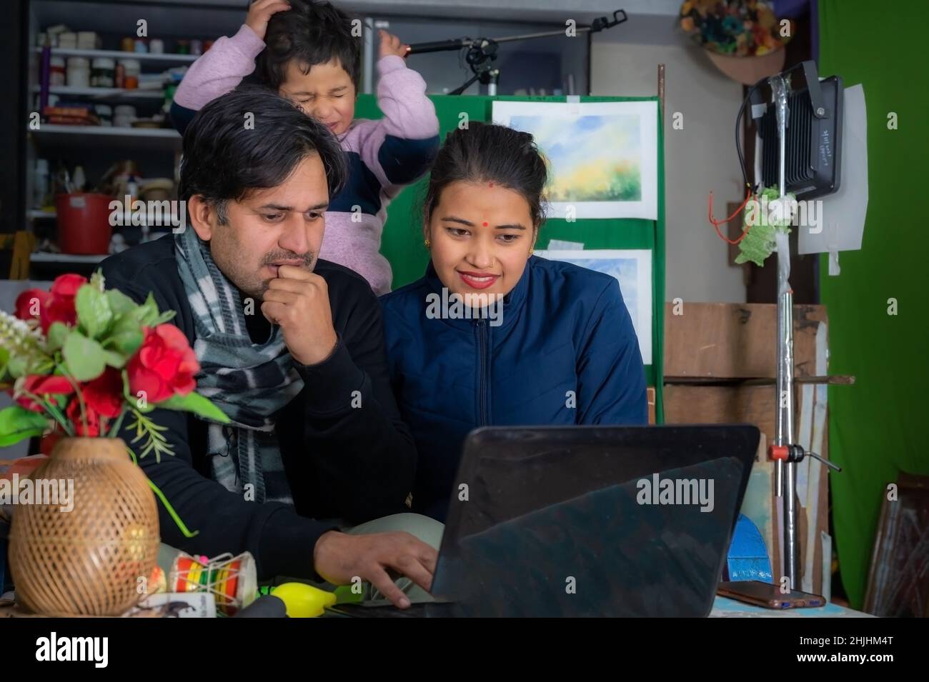 the parents are doing their office work and their child is troubling ...