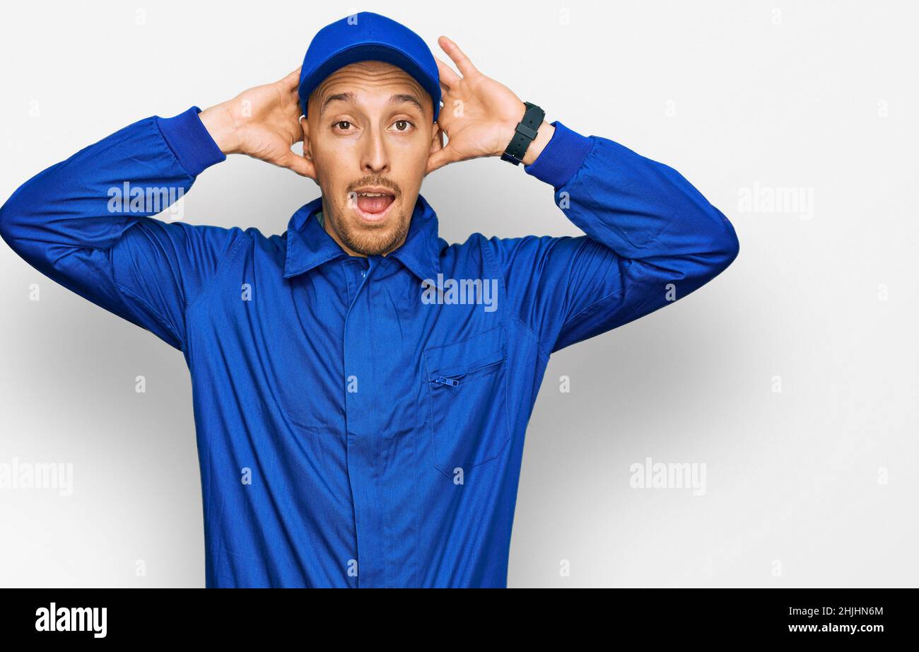 Bald man with beard wearing builder jumpsuit uniform crazy and scared ...