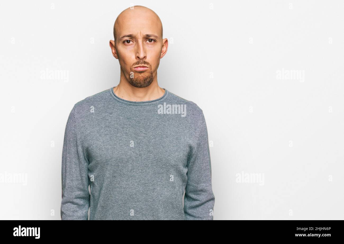 Bald man with beard wearing casual clothes depressed and worry for ...