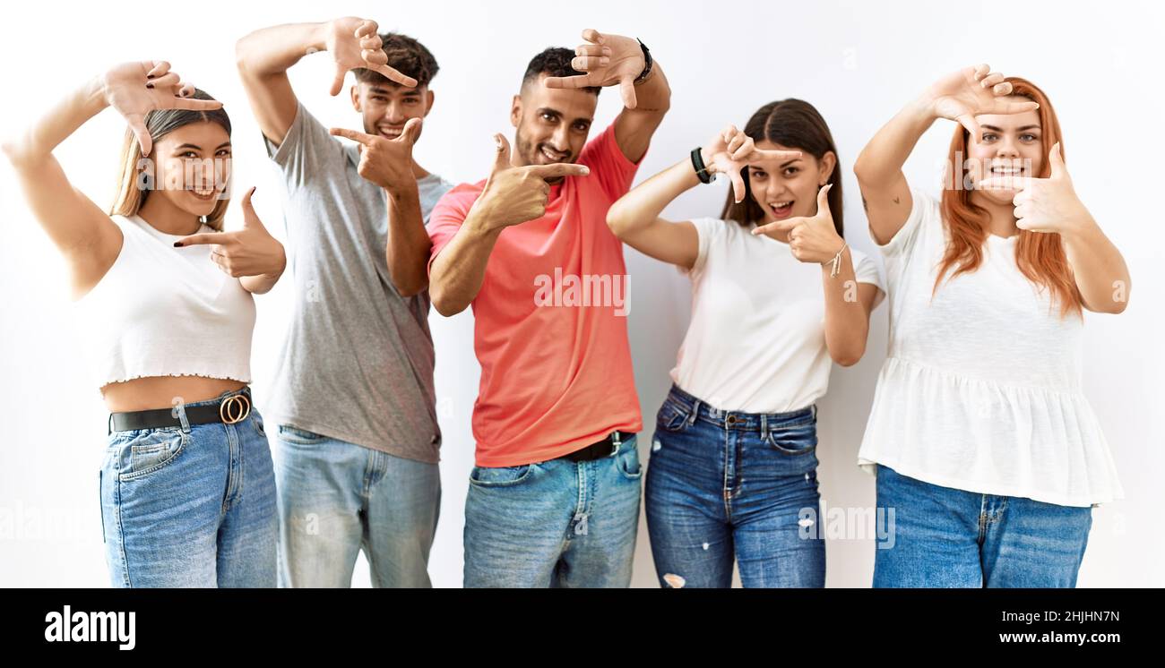 Group of young friends standing together over isolated background ...