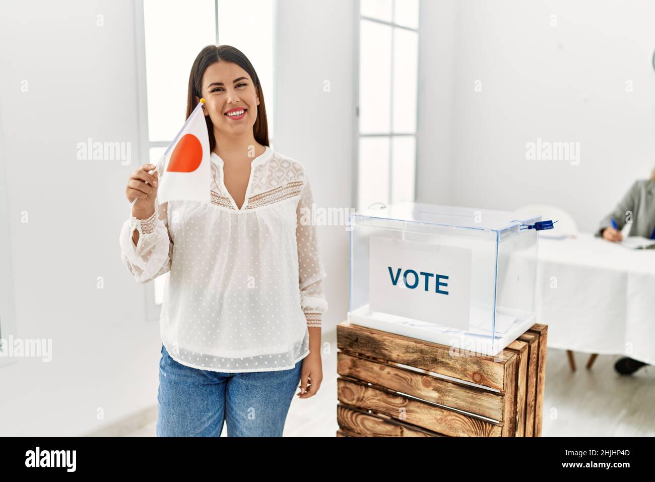 Young japanese voter woman smiling happy holding japan flag at ...