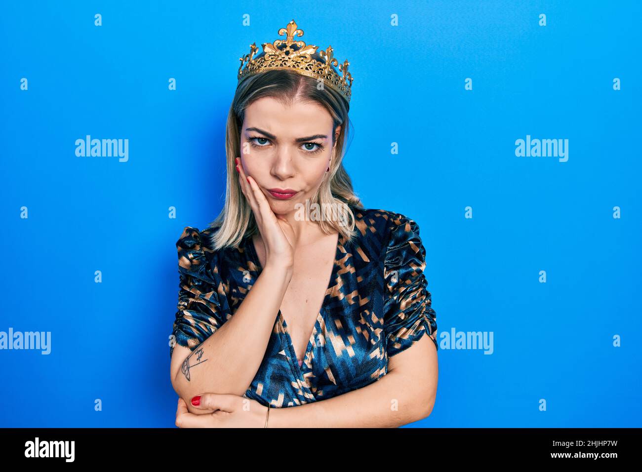 Beautiful caucasian woman wearing princess crown thinking looking tired ...