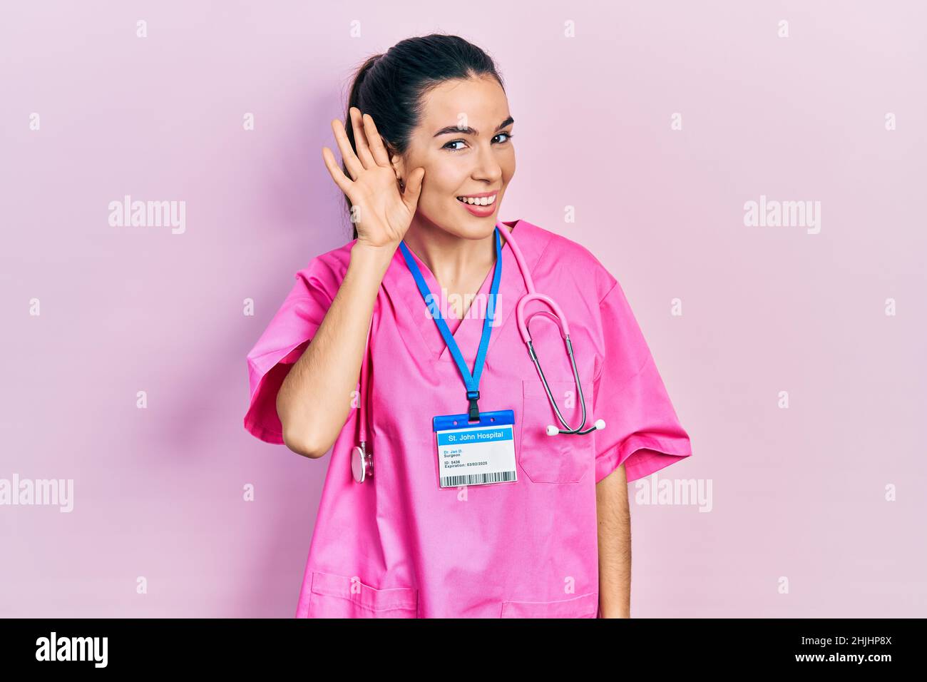 Young brunette woman wearing doctor uniform and stethoscope smiling ...