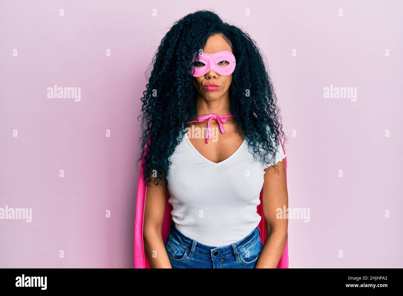 Middle age african american woman wearing super hero costume depressed ...