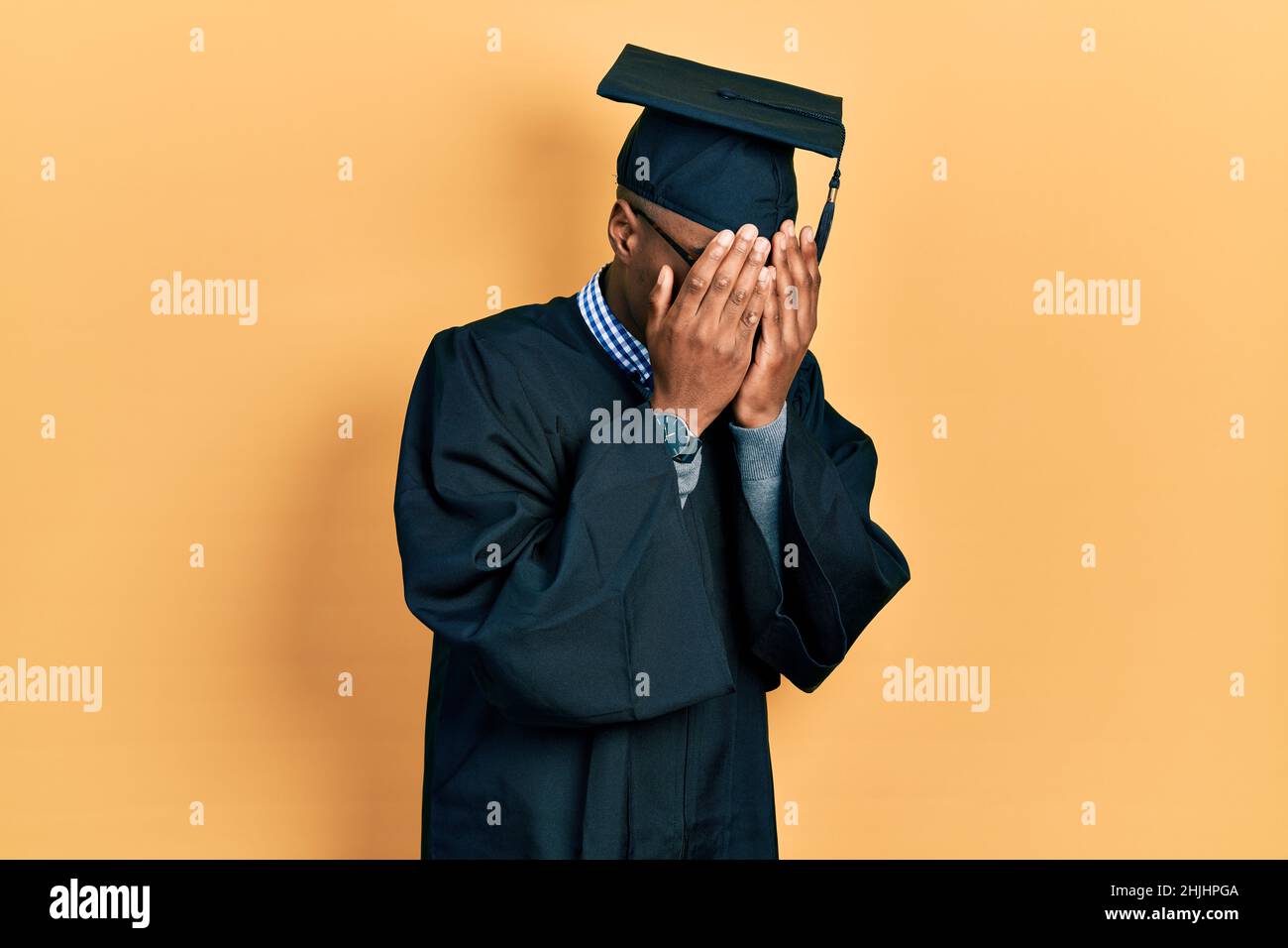 Young african american man wearing graduation cap and ceremony robe ...