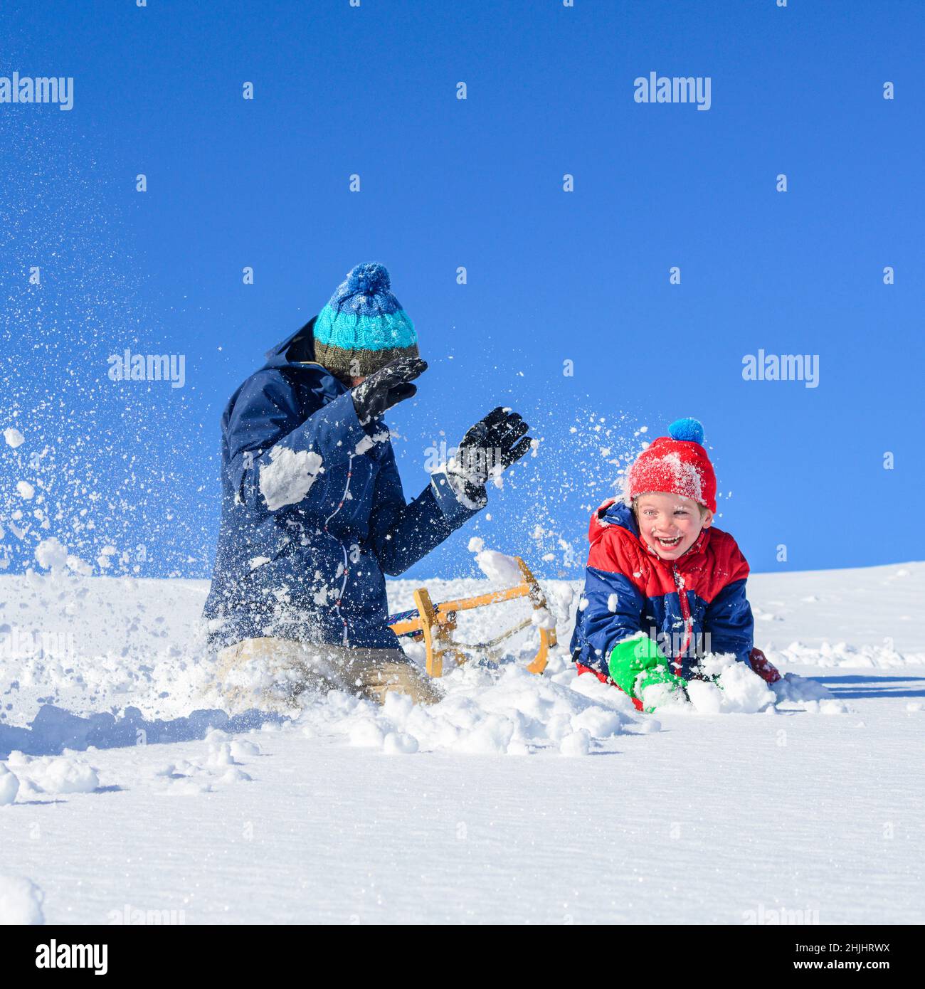 Young family has fun in snow Stock Photo - Alamy