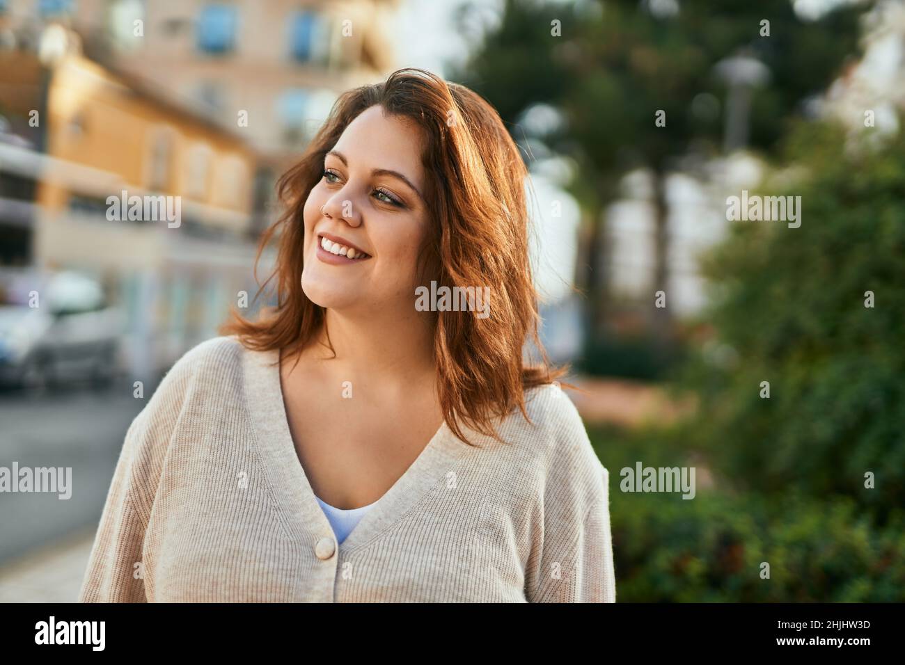 Young irish plus size girl smiling happy standing at the city Stock ...
