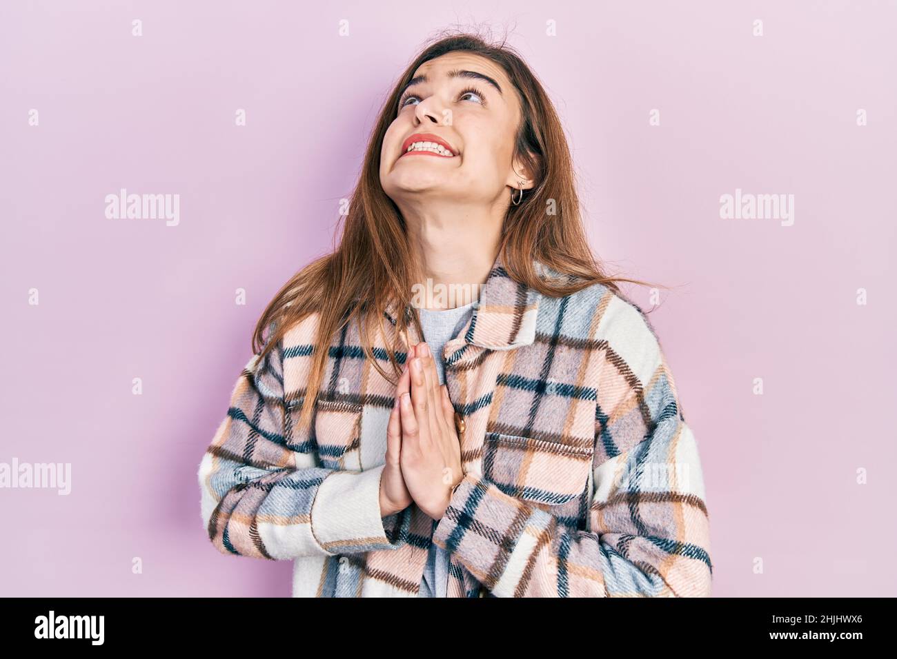Young caucasian girl wearing casual clothes begging and praying with ...