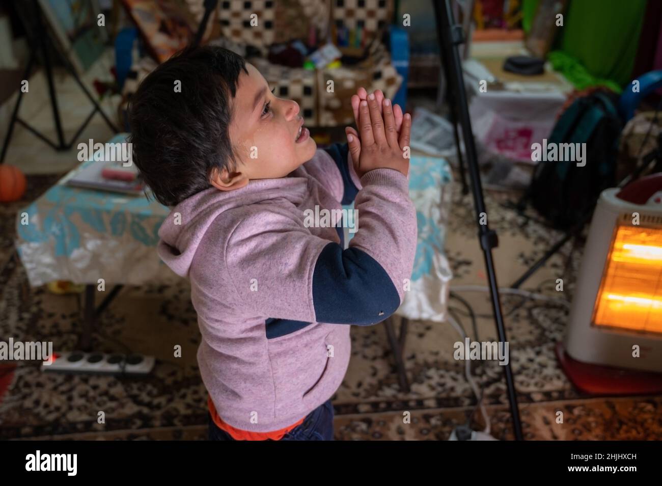 after making a mistake a small child apologizes to his father with ...