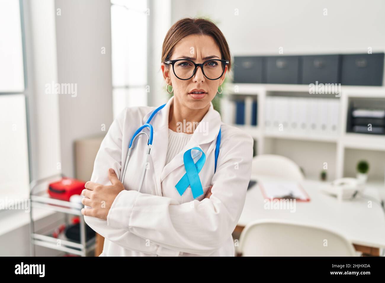 Young brunette doctor woman wearing stethoscope at the clinic skeptic ...