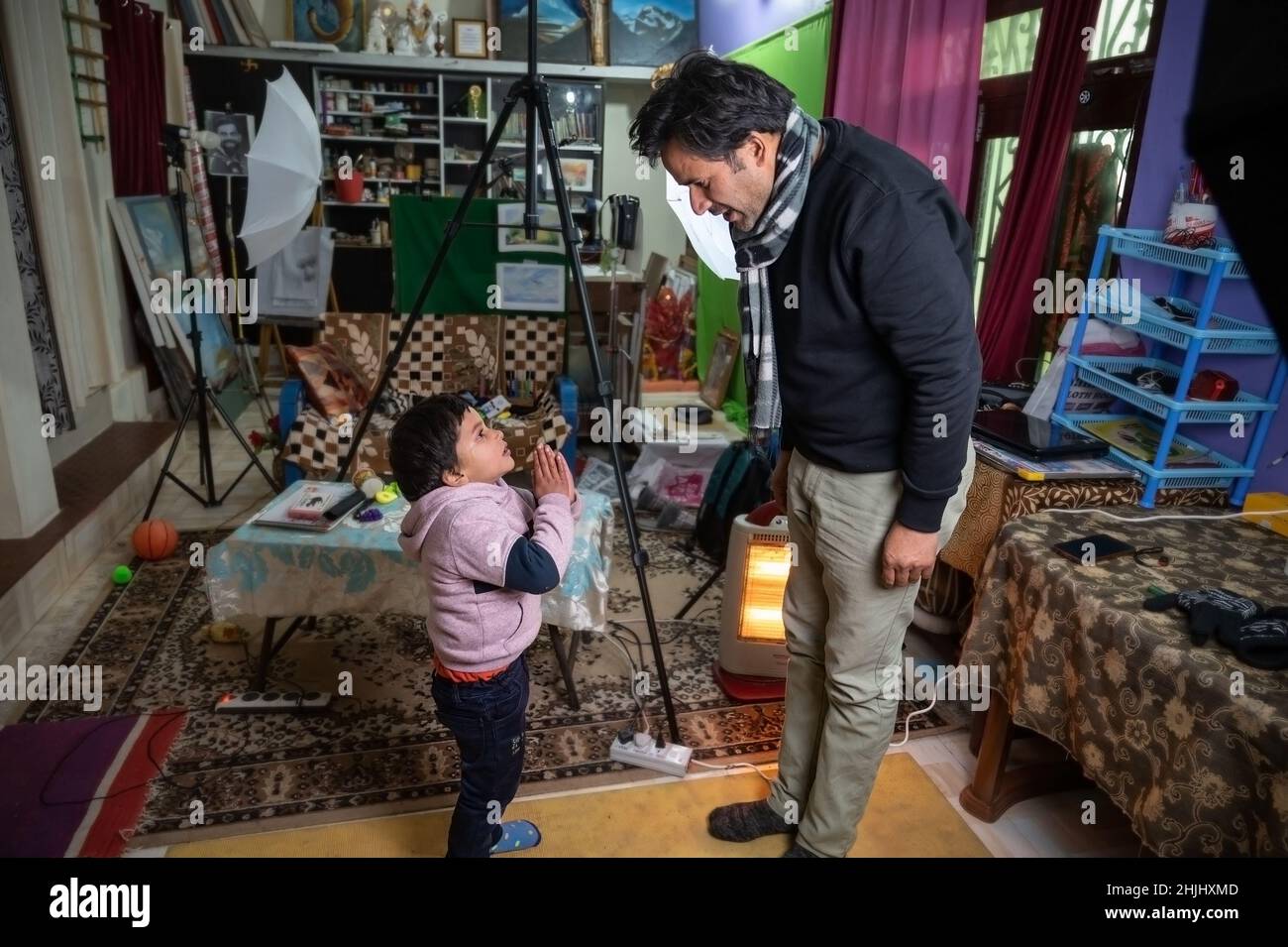 after making a mistake a small child apologizes to his father with ...