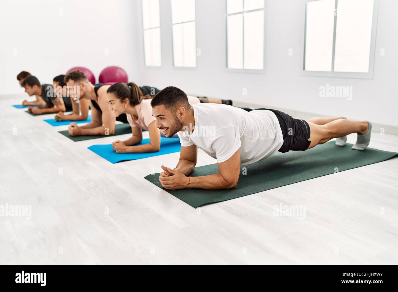 Group of young hispanic people smiling happy training abdominal ...