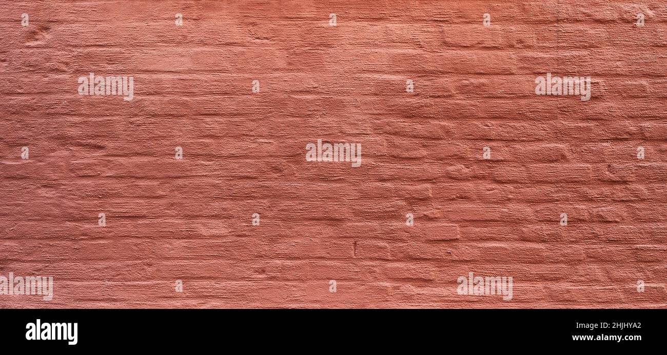 Painted red brick wall surface background Stock Photo - Alamy