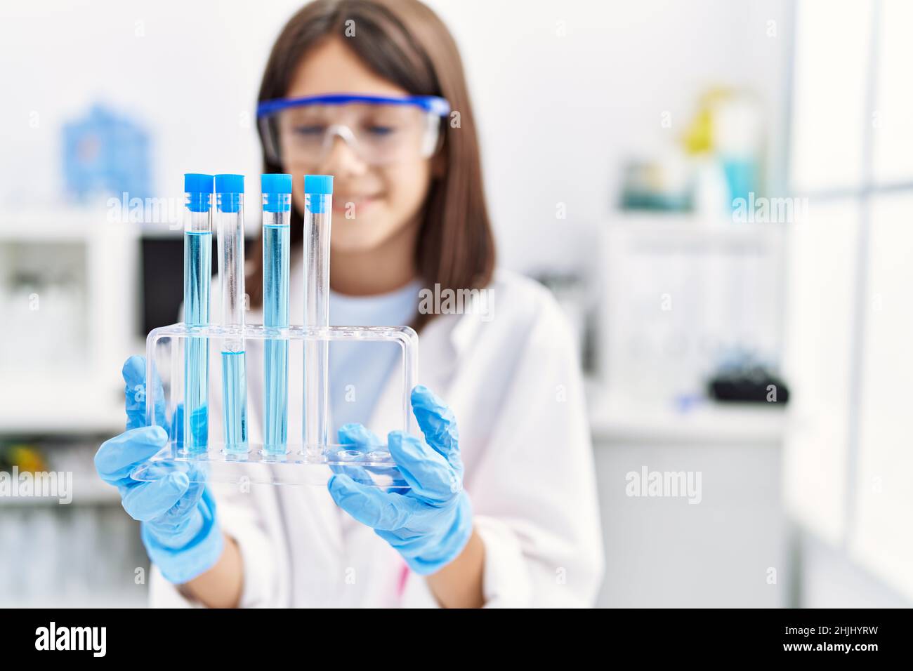 Young hispanic girl working at laboratory Stock Photo - Alamy