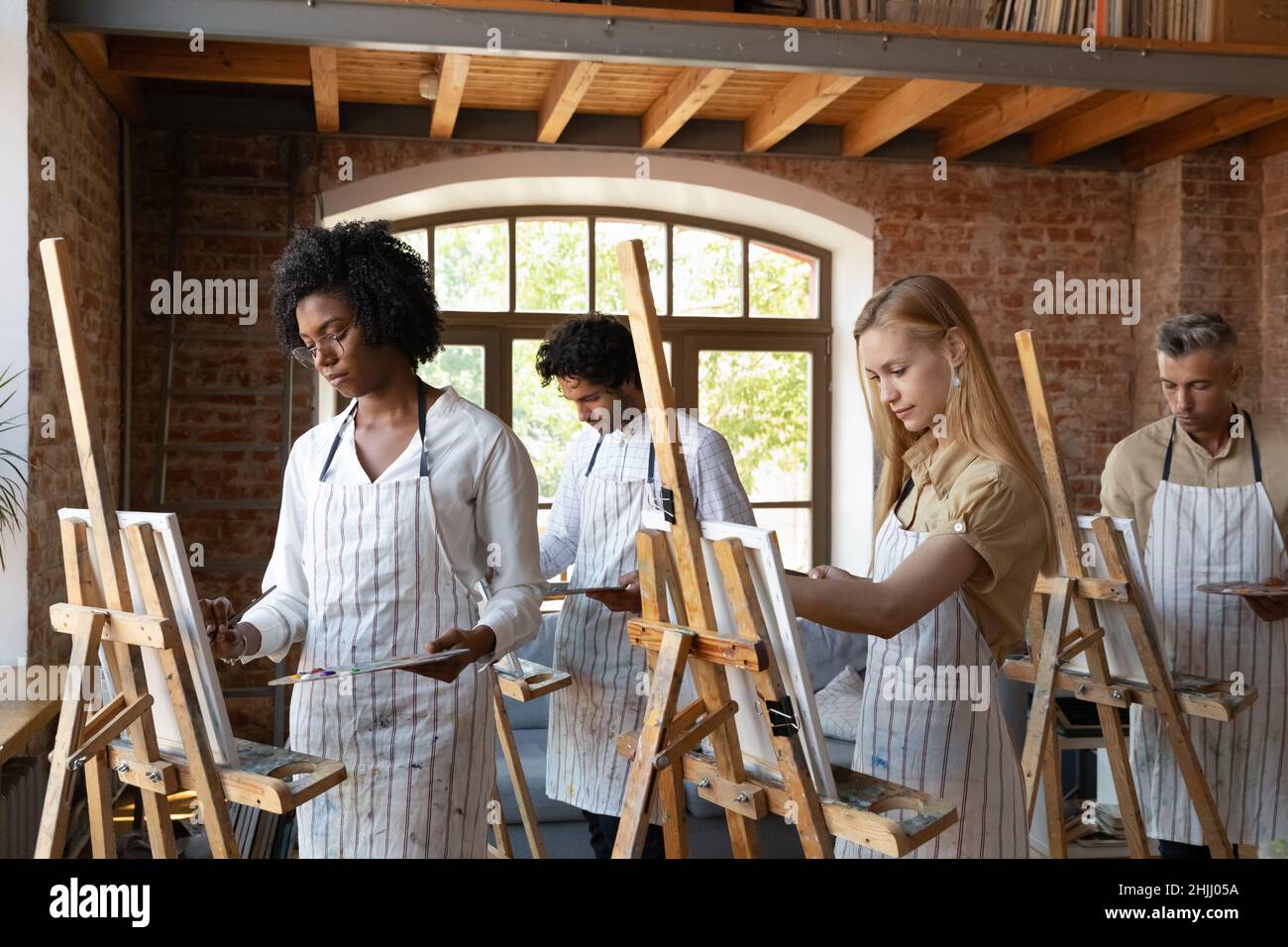 Multiethnic group of artist students drawing at easels Stock Photo - Alamy