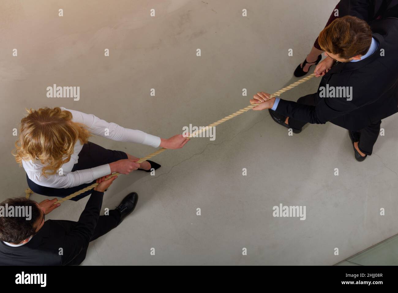 Group of business competitors pull a rope as a challenge Stock Photo ...