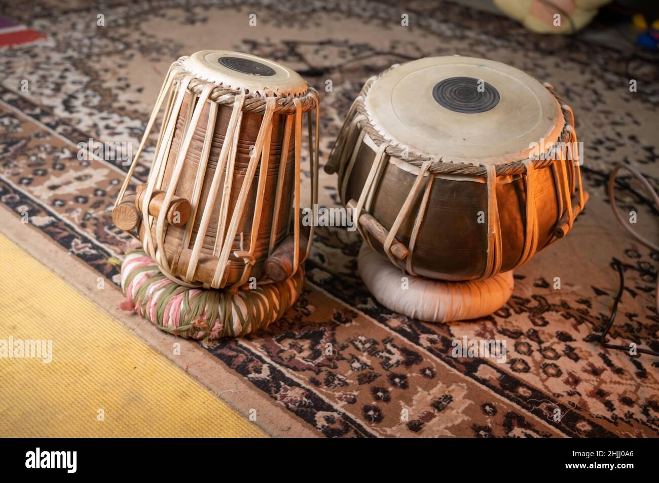 a small child trying to learning to play the tabla Stock Photo - Alamy