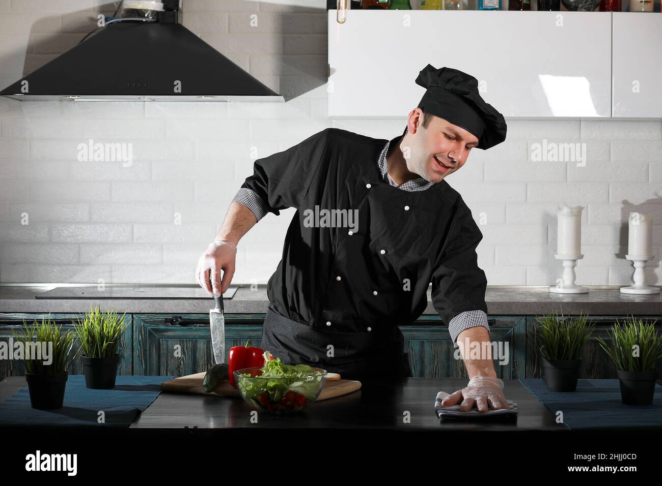 Man cook preparing food at the kitchen table of vegetables Stock Photo ...