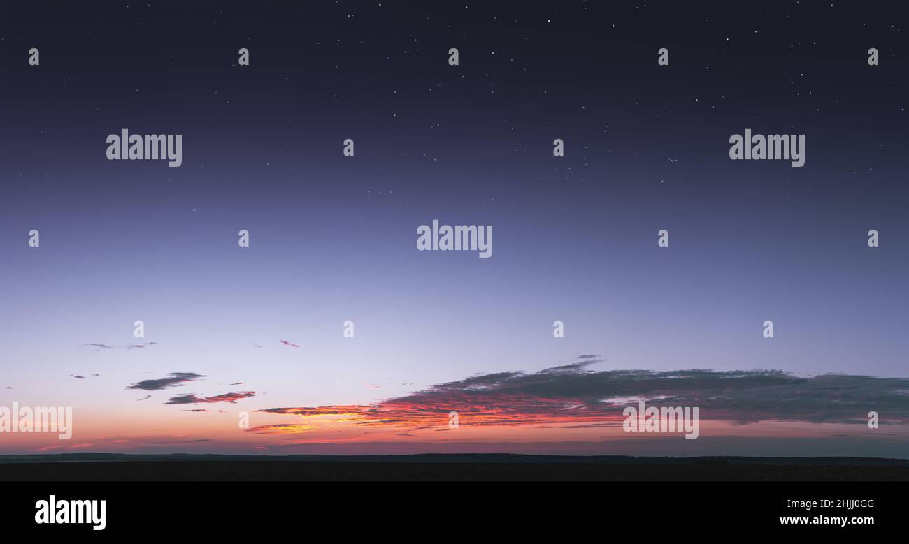 A bright colorful sunset with small saturated clouds against the ...