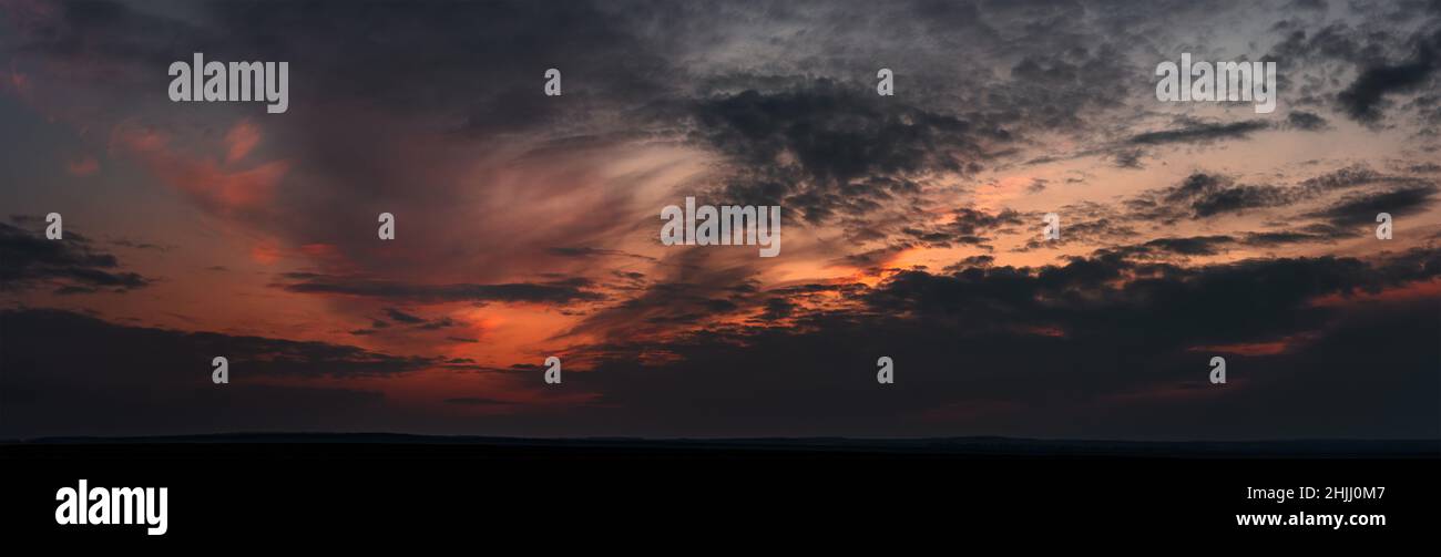 Dark sunset with gloomy clouds and red light on the horizon Stock Photo ...