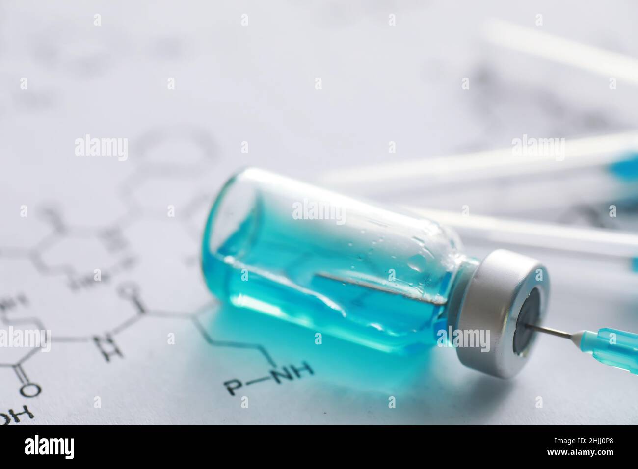 small jars with injection and syringe for injection on blue background ...