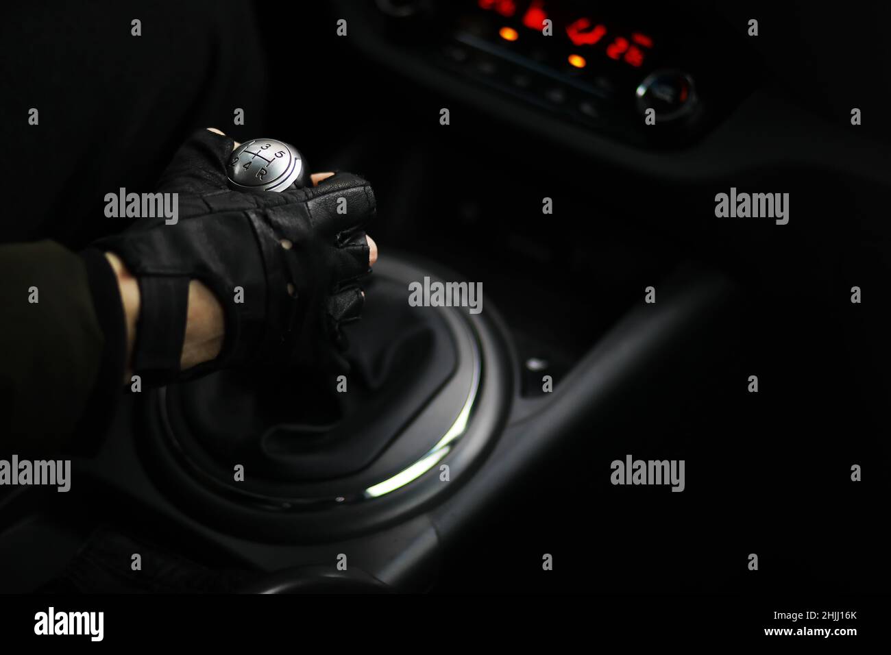 Hand on car gear knob. The driver switches the speed in the car. Hand ...