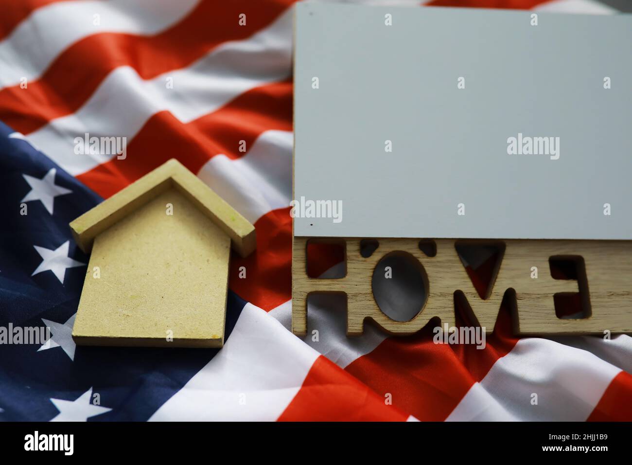 House symbol on American flag. Mortgage credit lending. Housing safety ...