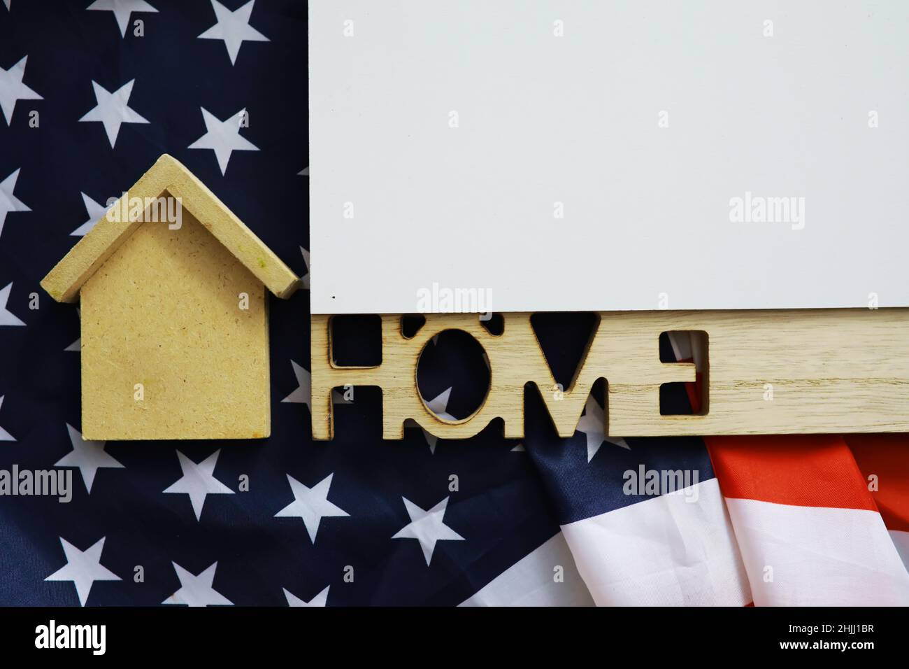 House symbol on American flag. Mortgage credit lending. Housing safety ...