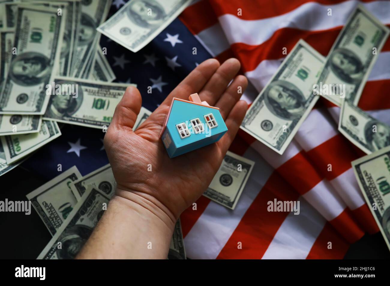 House symbol on American flag. Mortgage credit lending. Housing safety ...