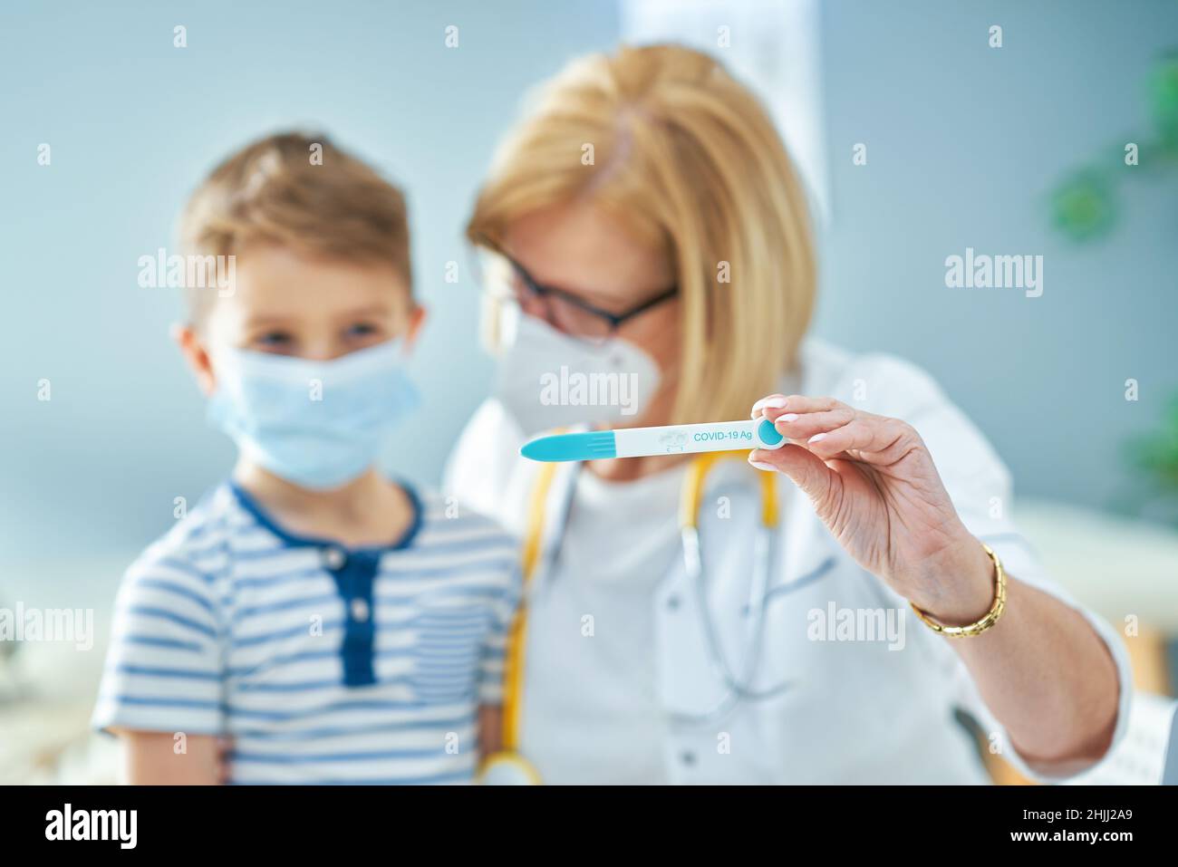 Pediatrician doctor examining little kids in clinic covid test Stock ...