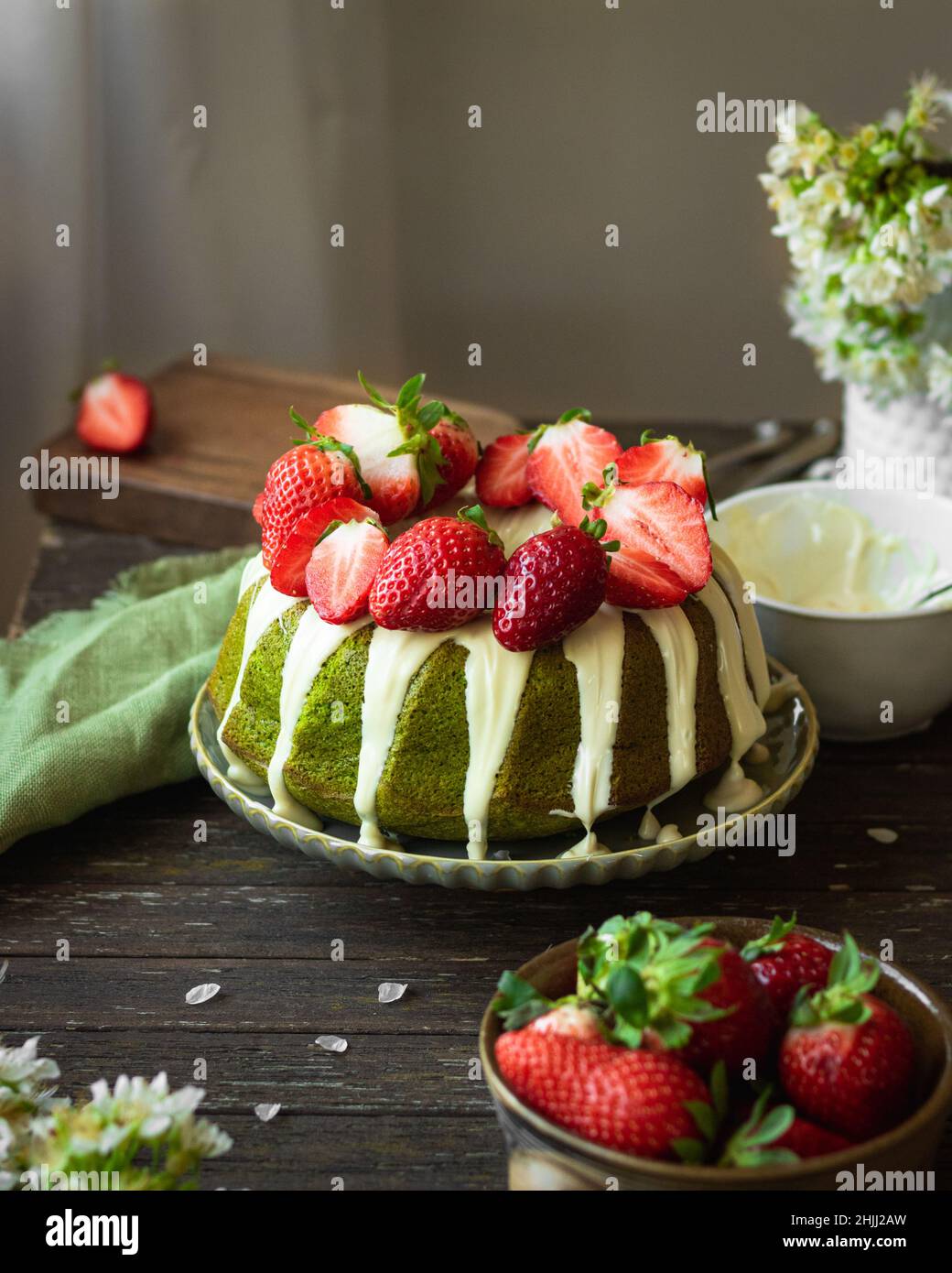 Green spinach cake with strawberry on a dark rustic wooden background ...