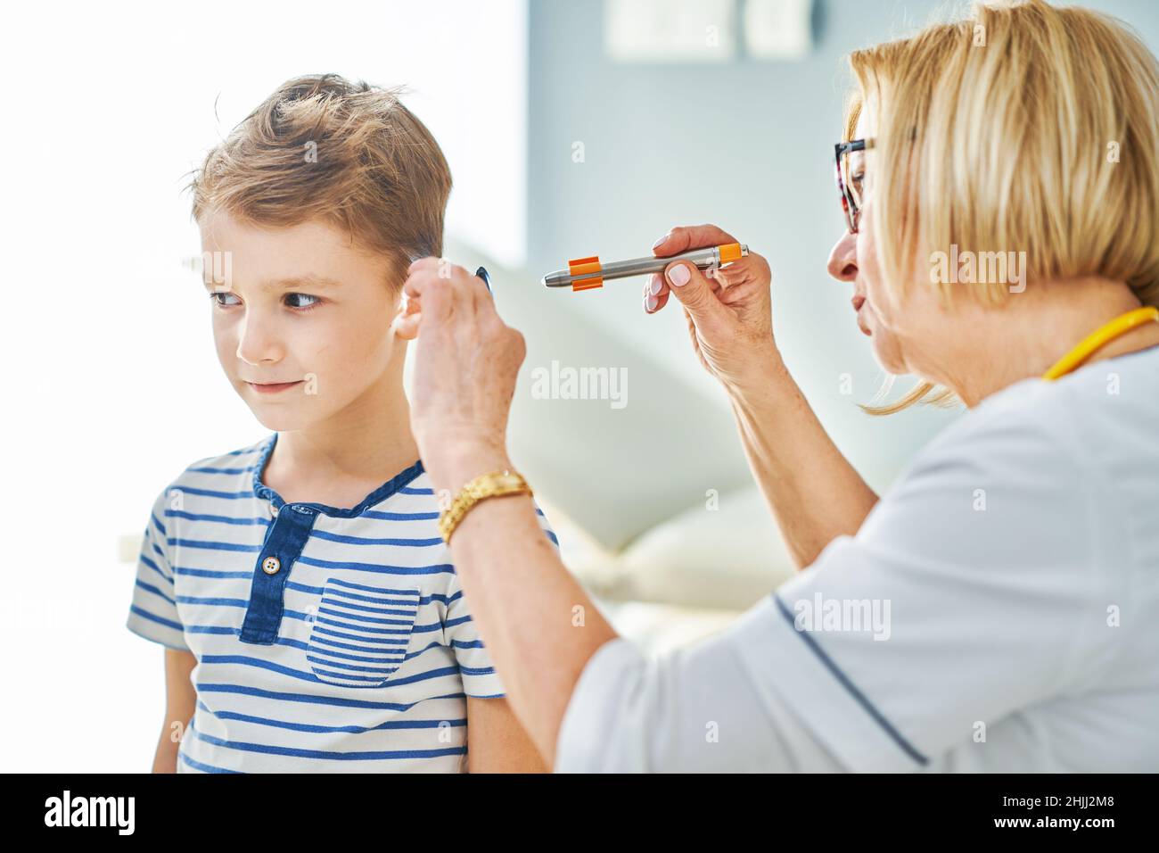 Pediatrician doctor examining little kids in clinic ears check Stock ...