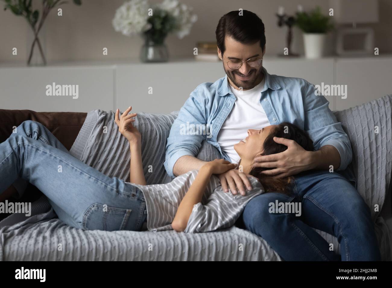 Couple flirting on sofa hi-res stock photography and images - Alamy