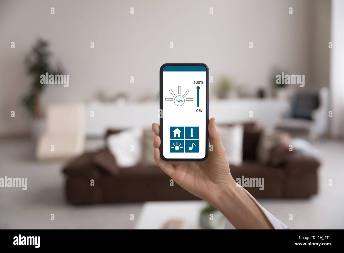 Female hand holds cellphone with smart home interface mobile ...