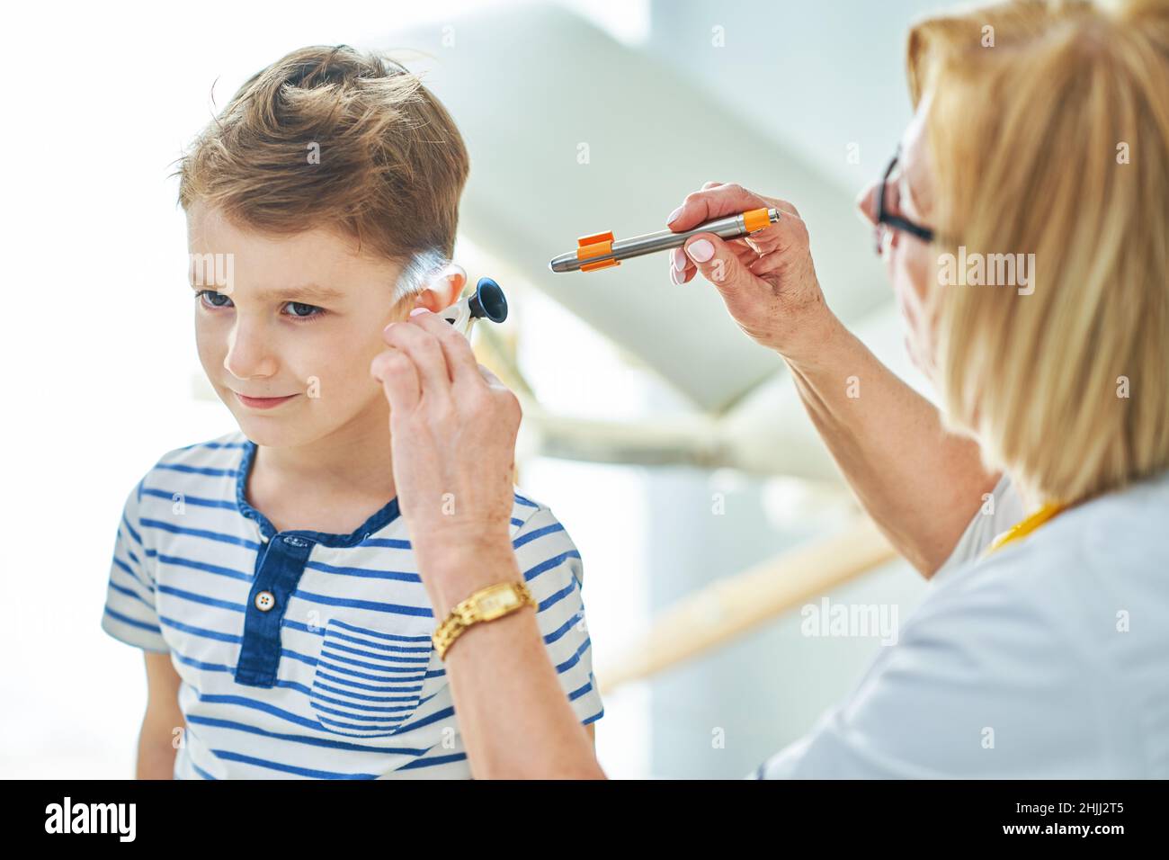 Pediatrician doctor examining little kids in clinic ears check Stock ...
