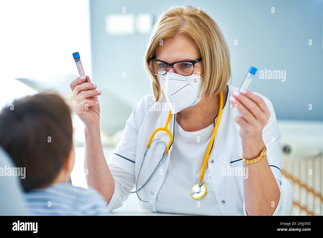 Pediatrician doctor examining little kids in clinic blood test Stock ...