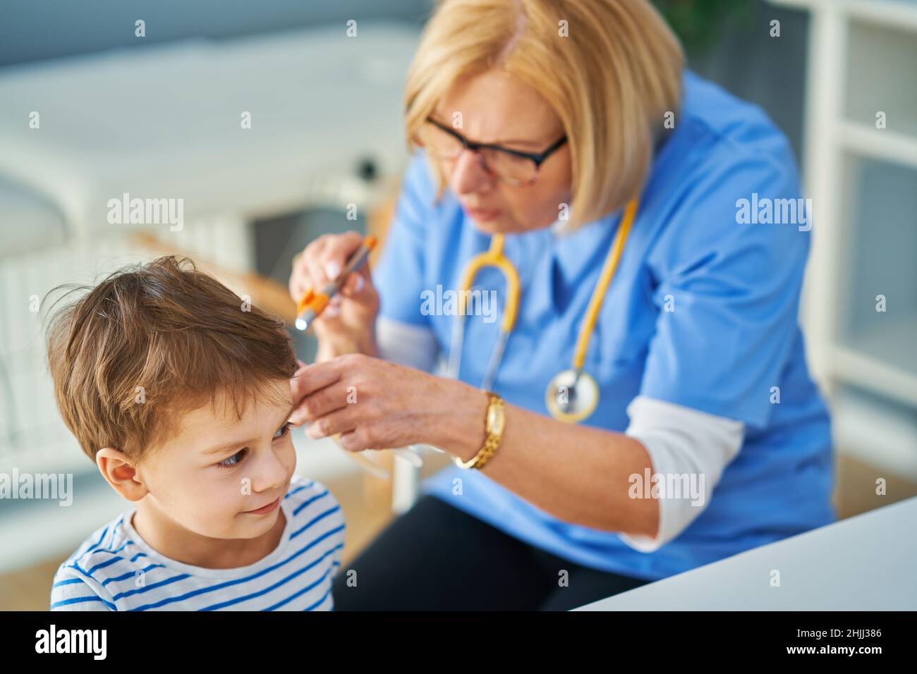 Pediatrician doctor examining little kids in clinic ears check Stock ...