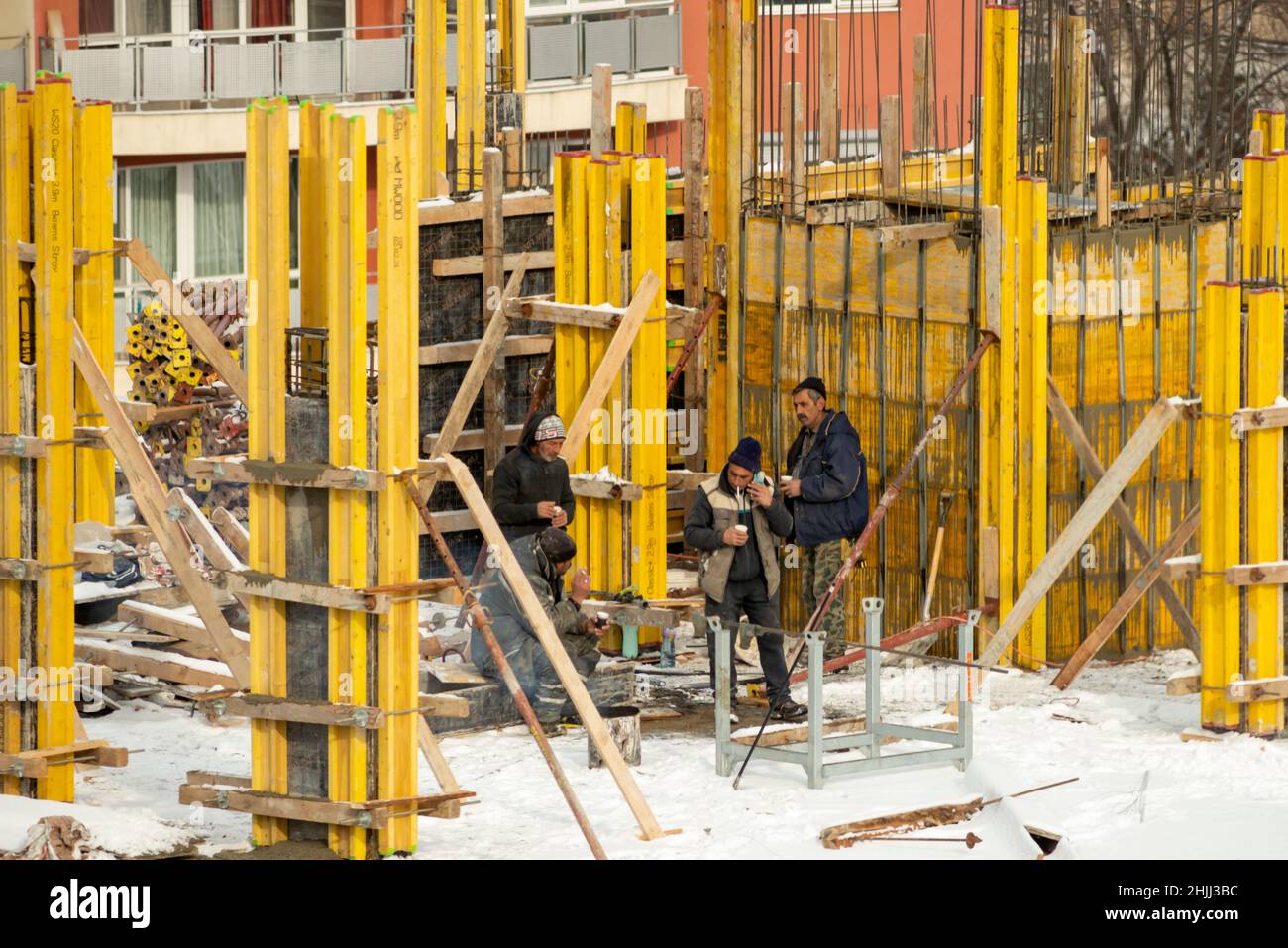 Workers having a break at a construction site in snowy winter, Sofia ...