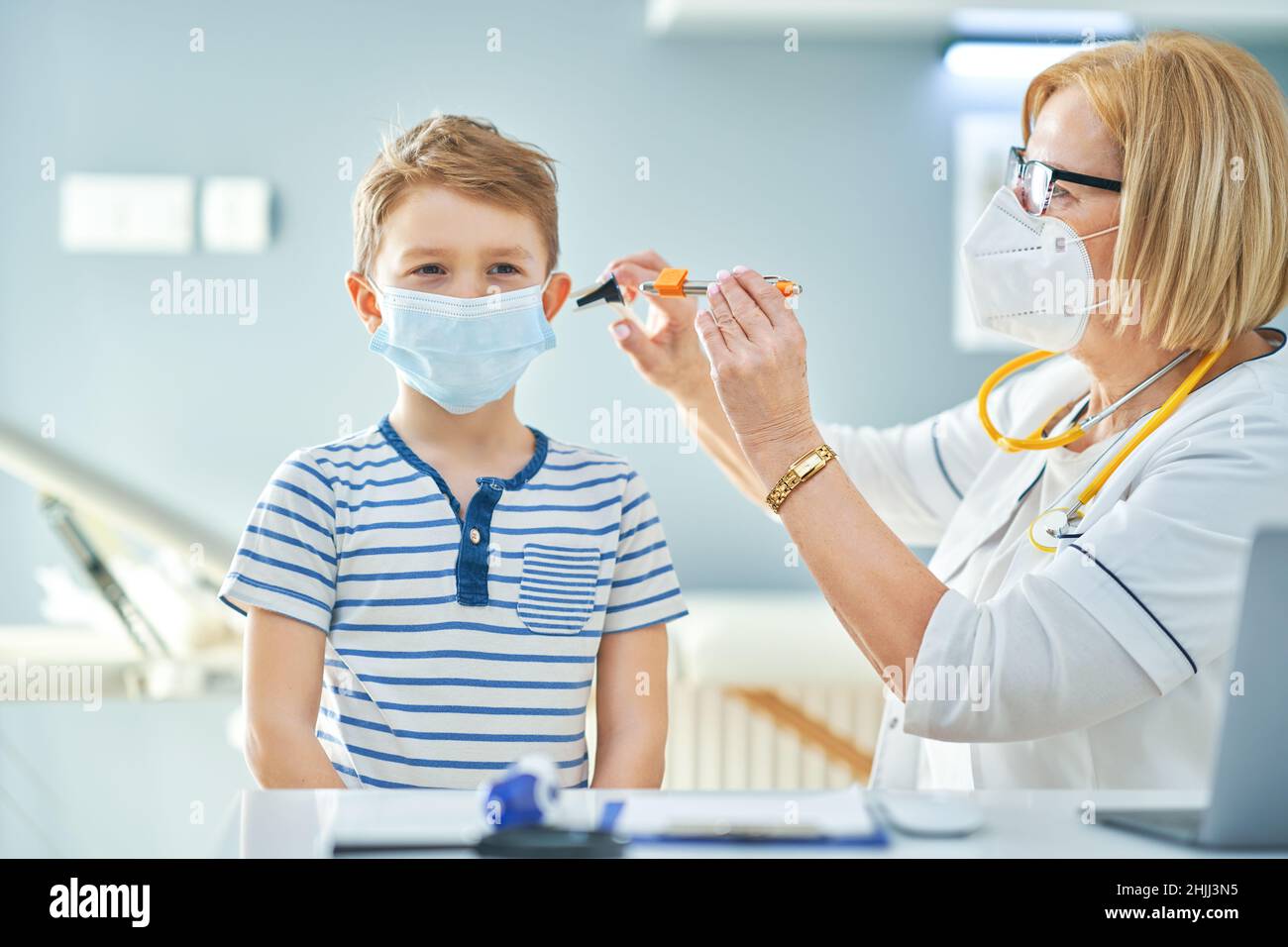 Pediatrician doctor examining little kids in clinic ears check Stock ...